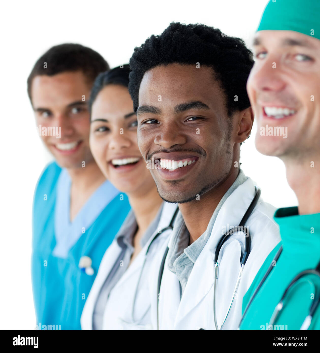 Young medical people smiling at the camera against a white background ...