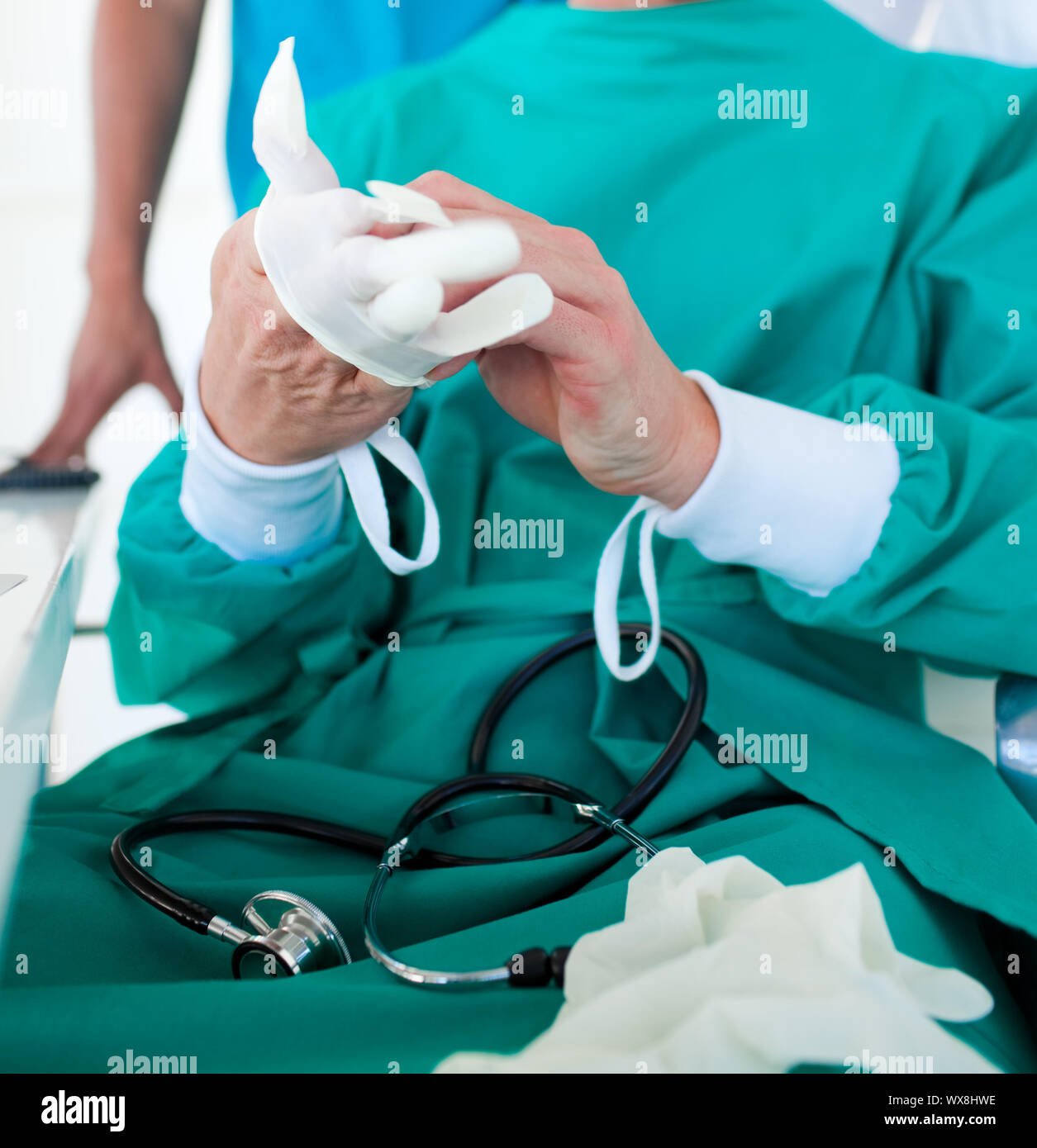 Close-up of a surgeon putting on his surgical gloves in a hospital ...
