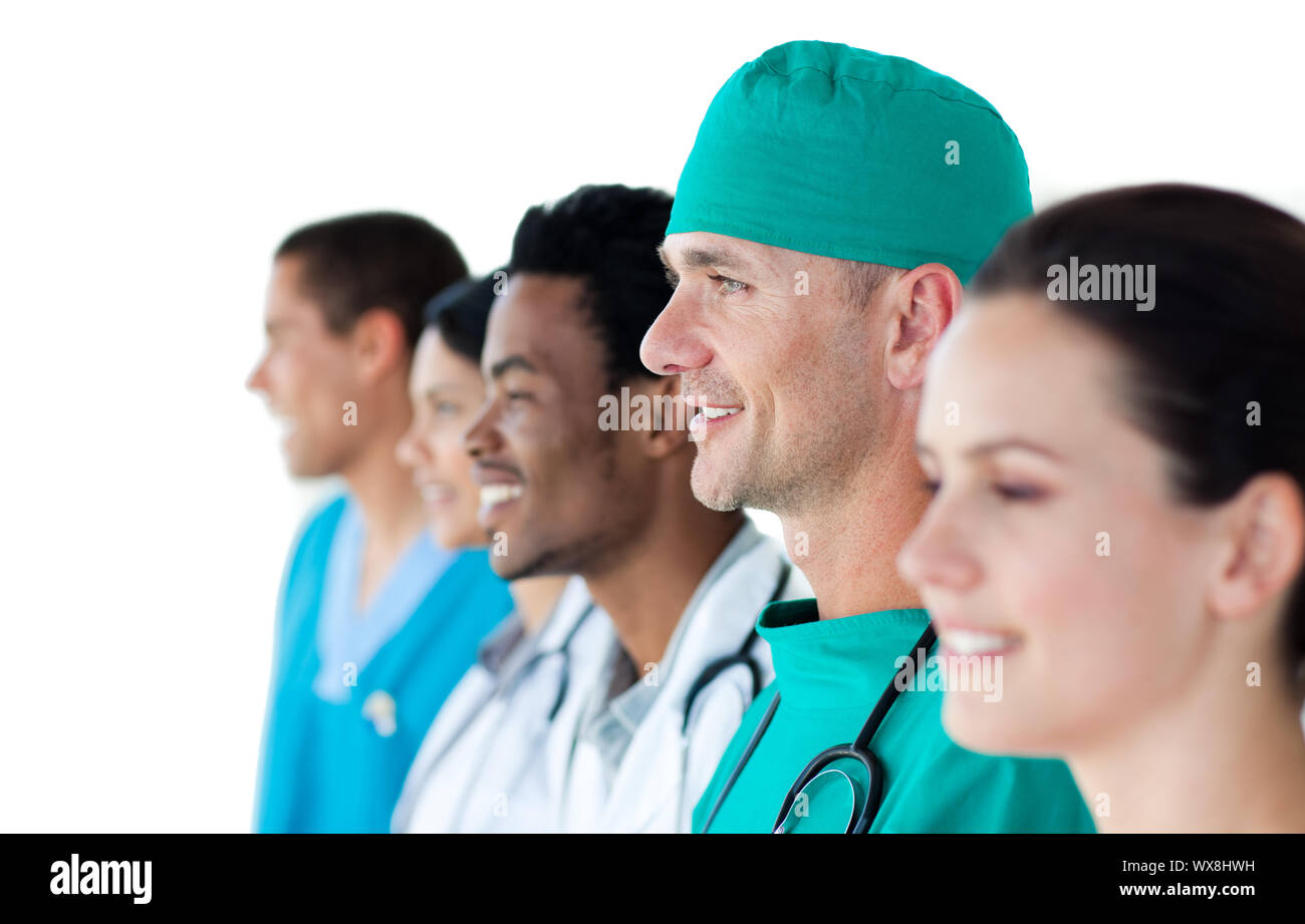 Multi-ethnic medical group standing in a line isolated on a white ...