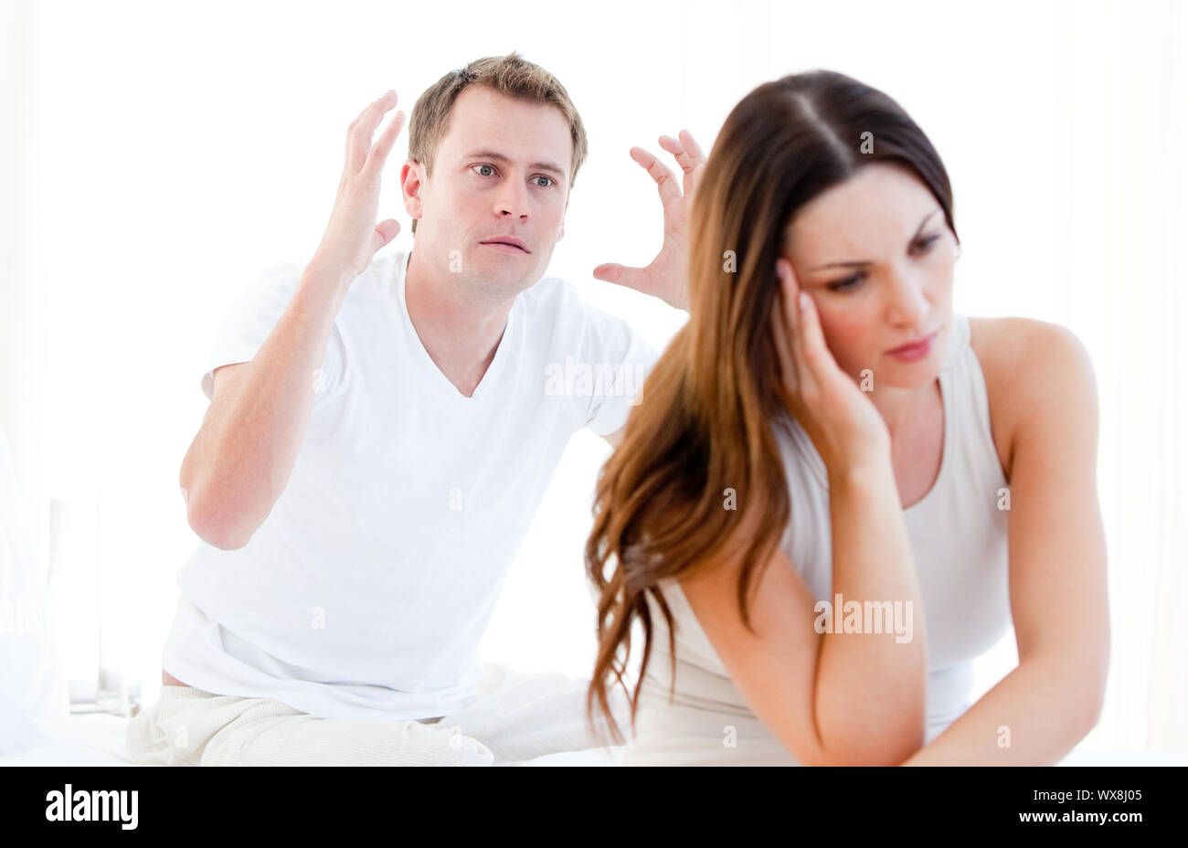 Caucasian couple argumenting against a white background Stock Photo - Alamy