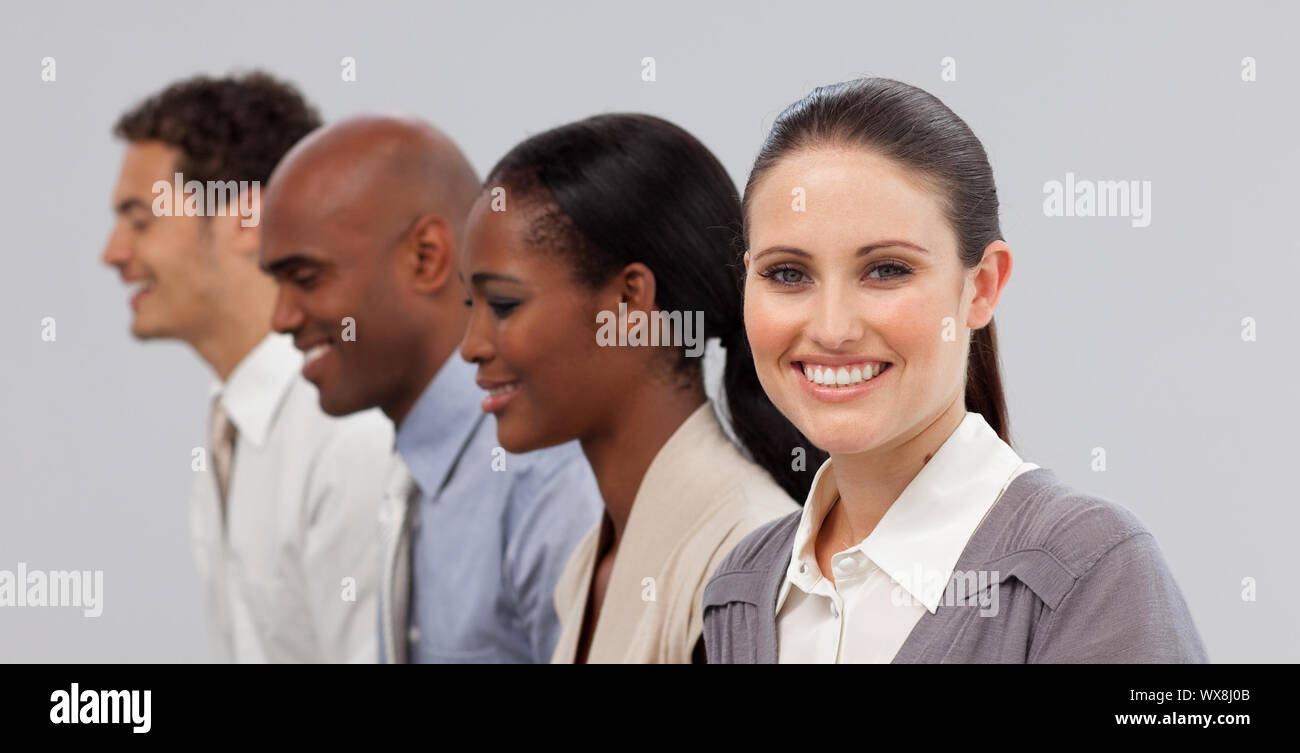 Diverse young business people sitting in a line in the office Stock ...