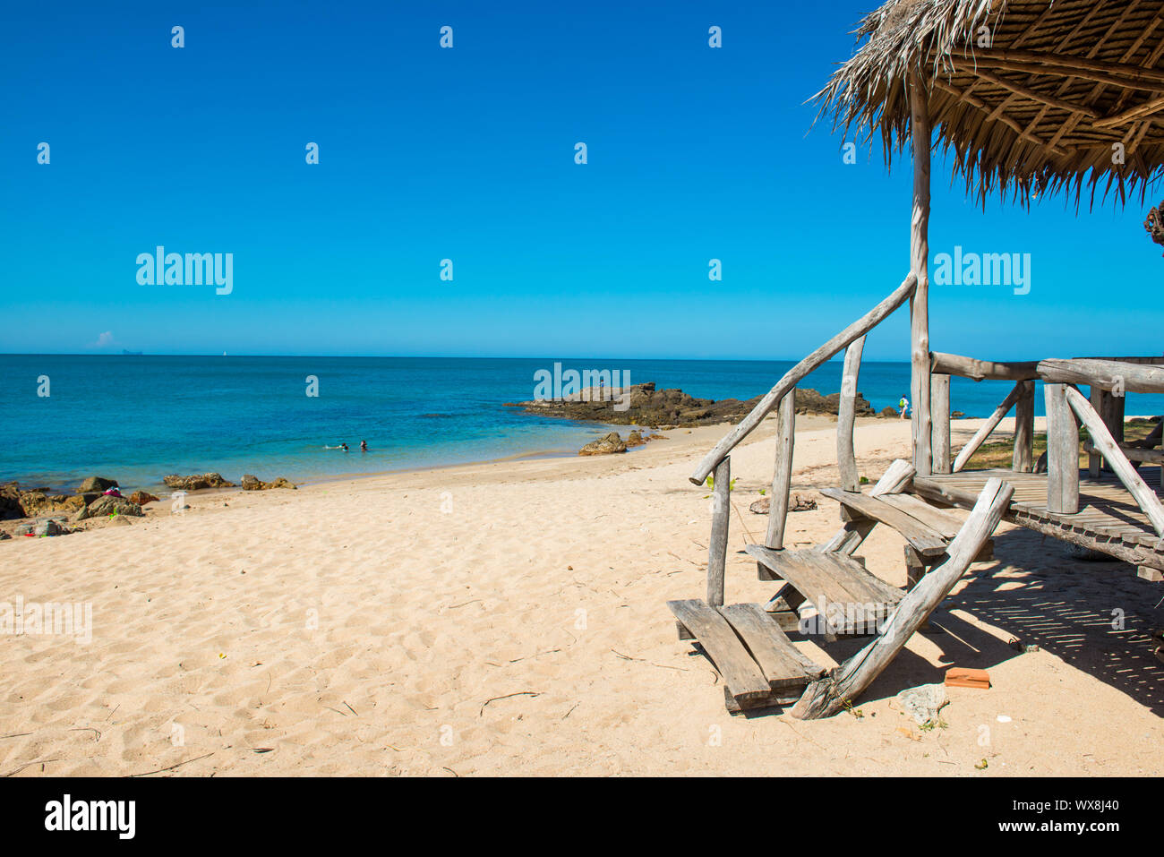 View of sand beach and hut at tropical island Stock Photo - Alamy