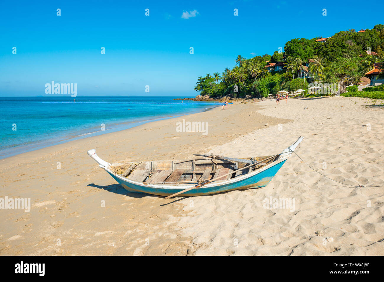 Tropical landscape with boat at sand beach Stock Photo - Alamy