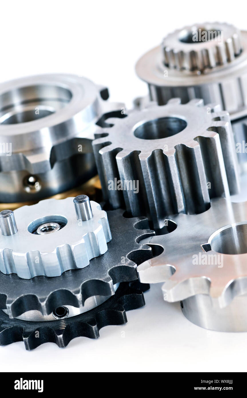 Interlocking industrial metal gears isolated on white Stock Photo - Alamy
