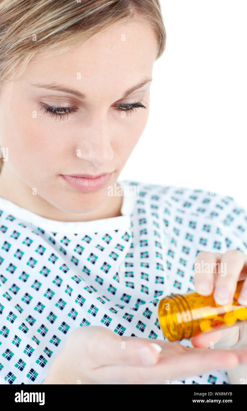Woman taking pills against white background Stock Photo - Alamy