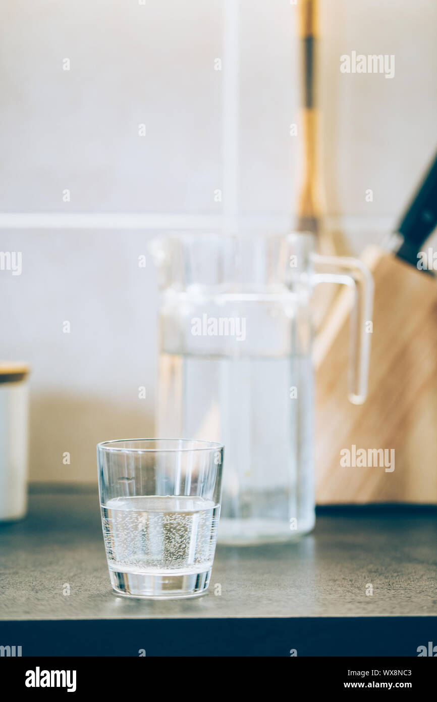 Glass of pure water on kitchen table Stock Photo - Alamy