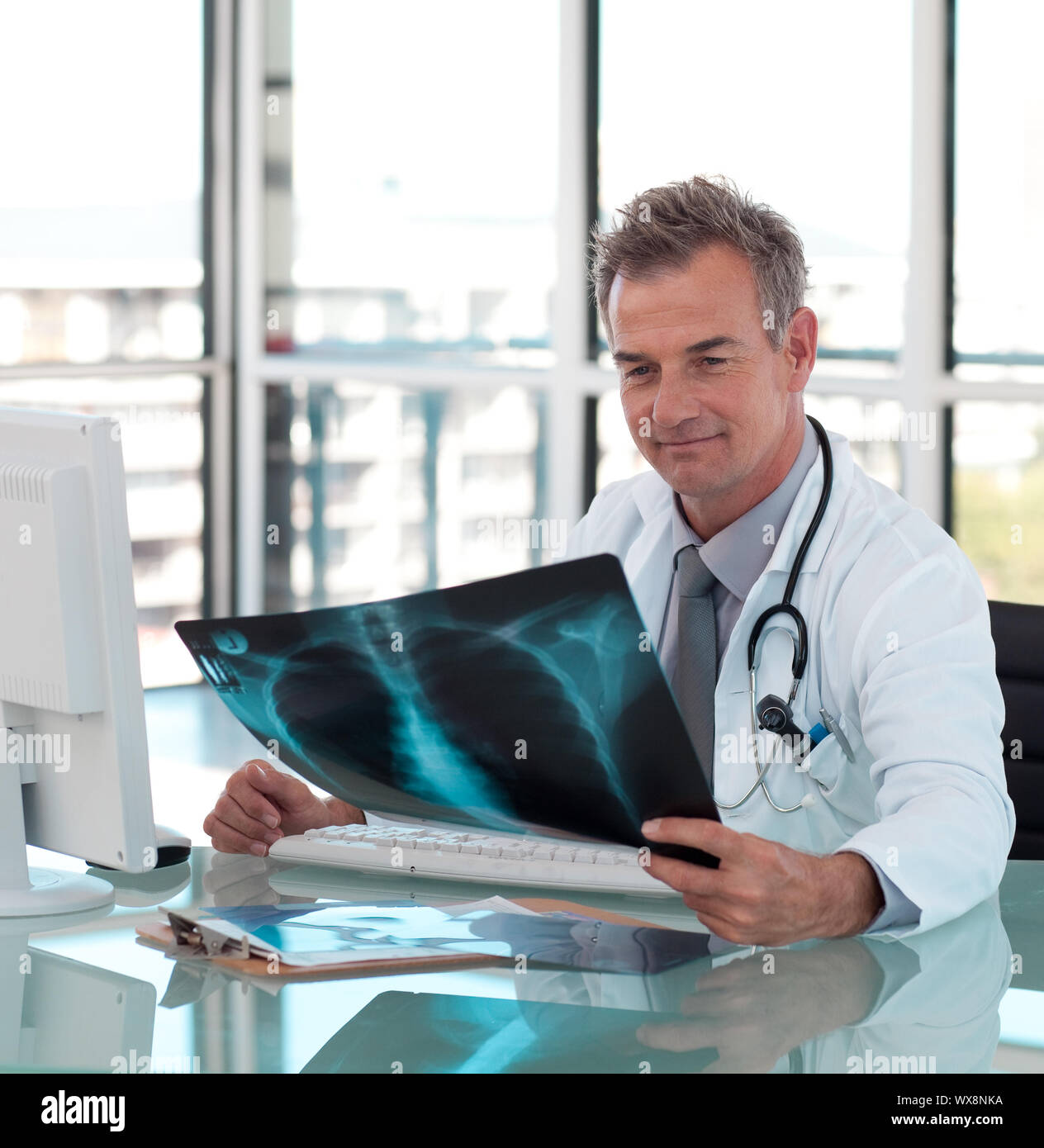 Portrait of a charming male doctor studying a x-ray Stock Photo - Alamy