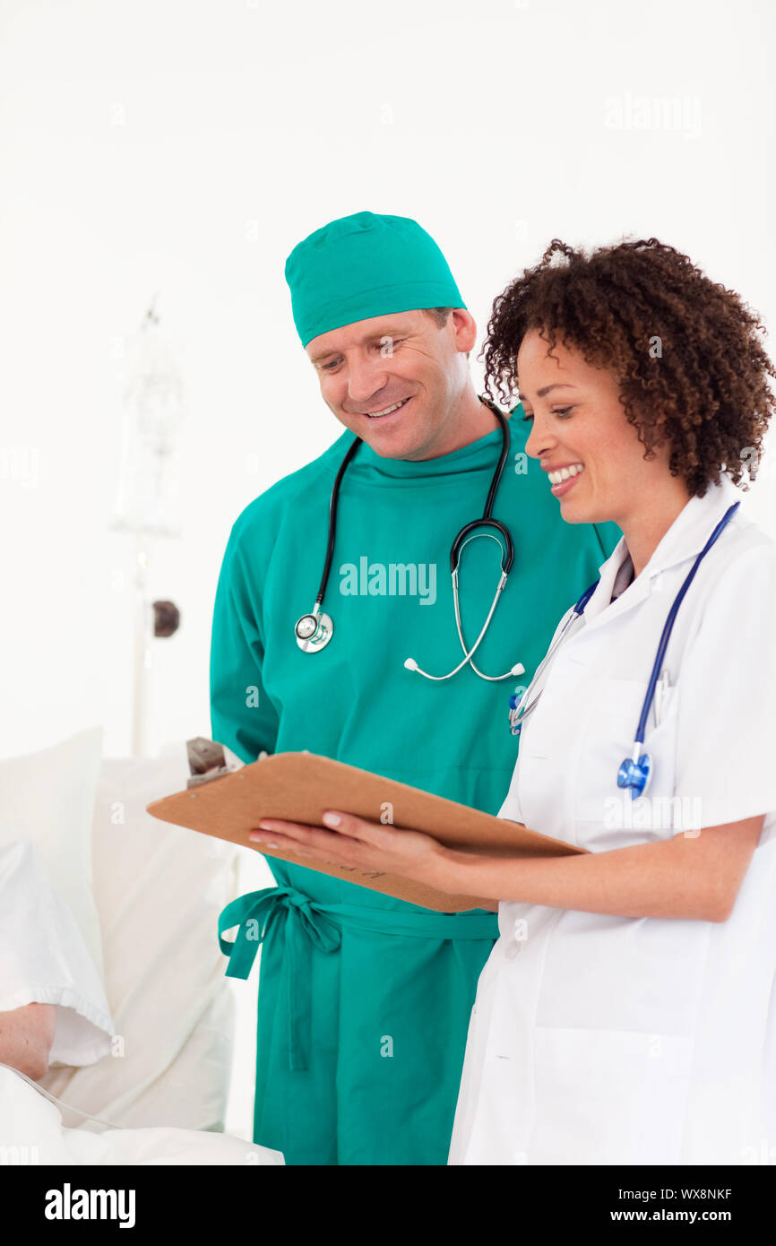 Nice female doctor with surgeon holding a paper Stock Photo - Alamy