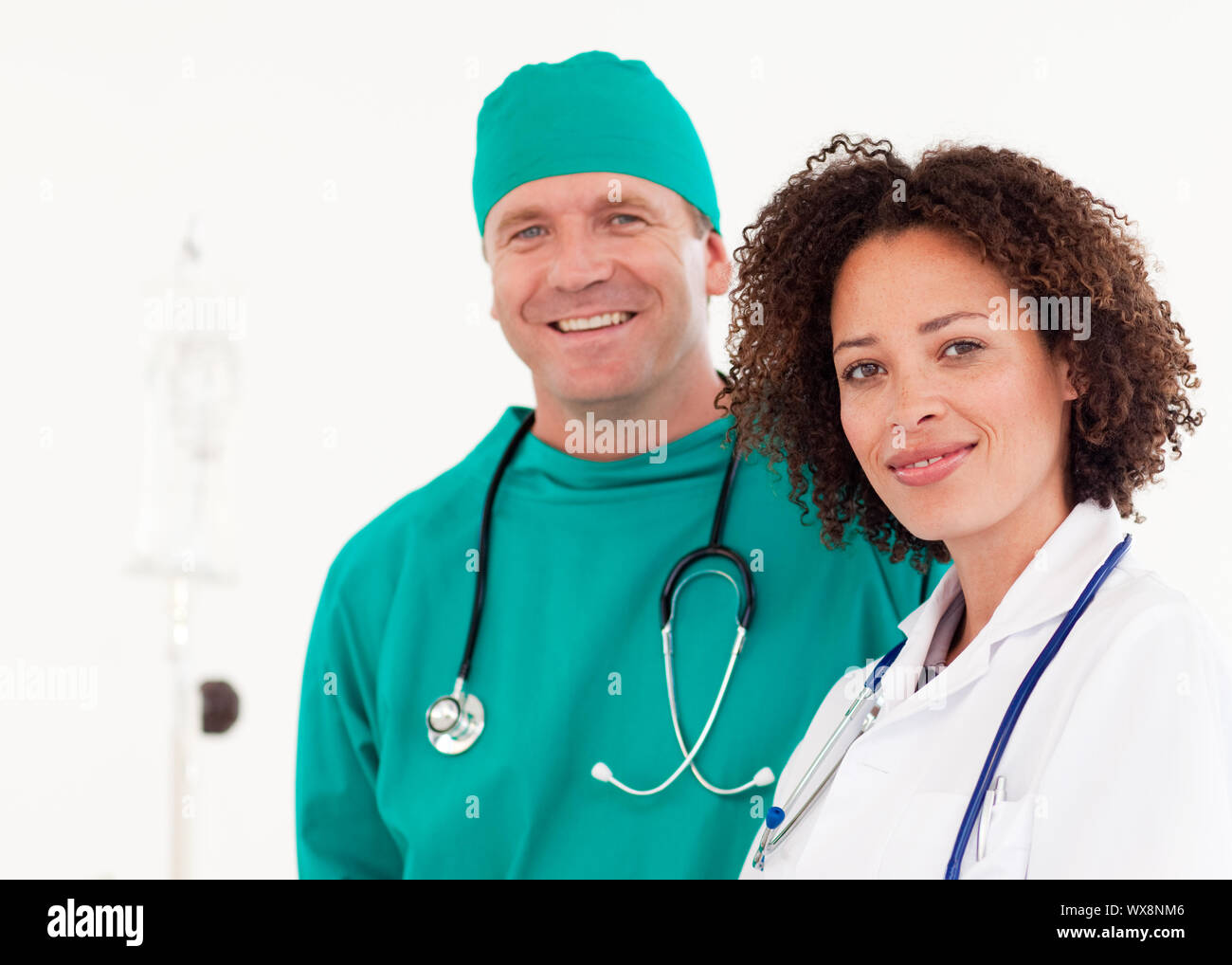 Portrait of a glowing doctor with surgeon in green scrubs in a hospital ...