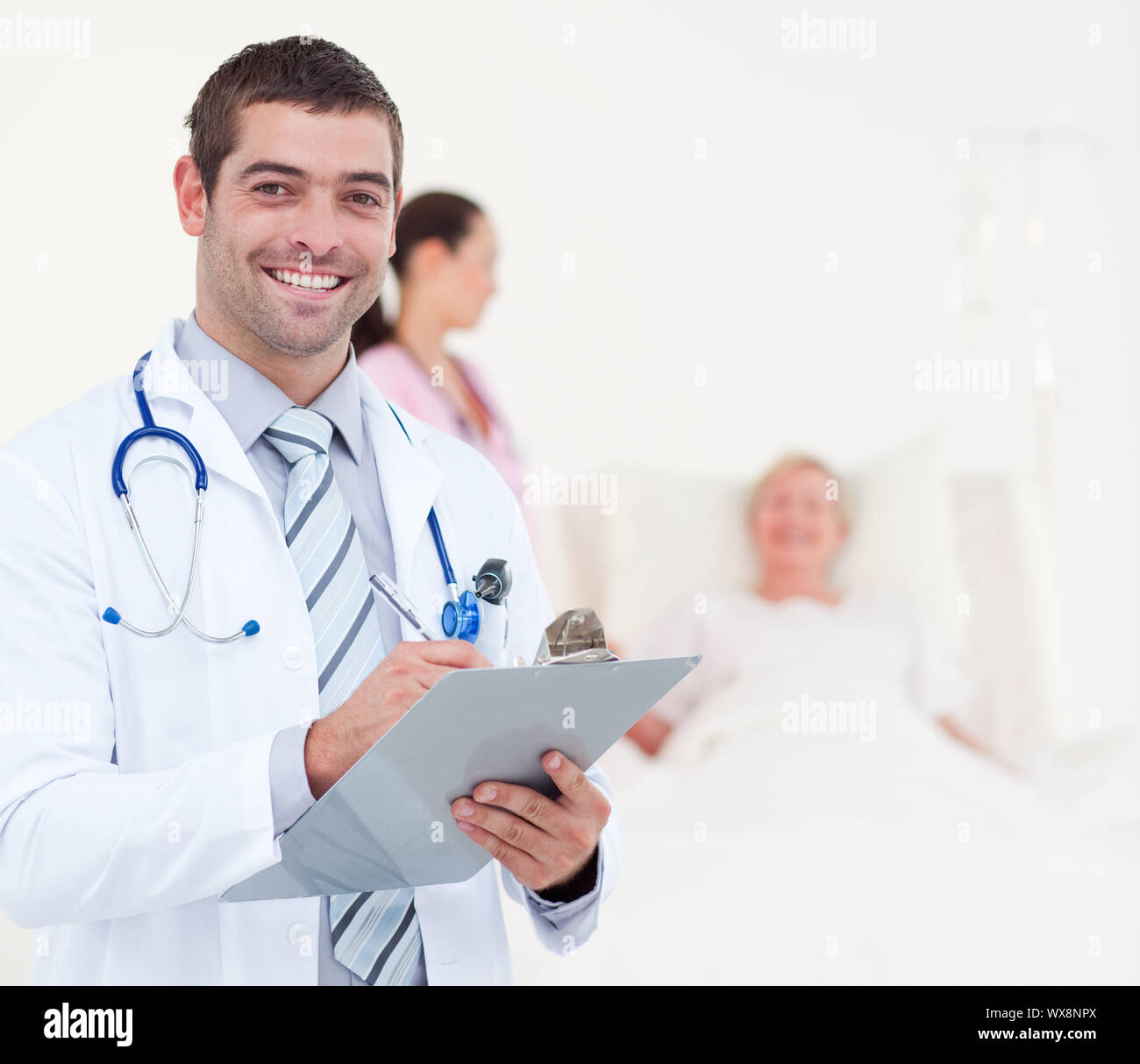 Confident chief physician in a hospital writing on a clip board Stock ...