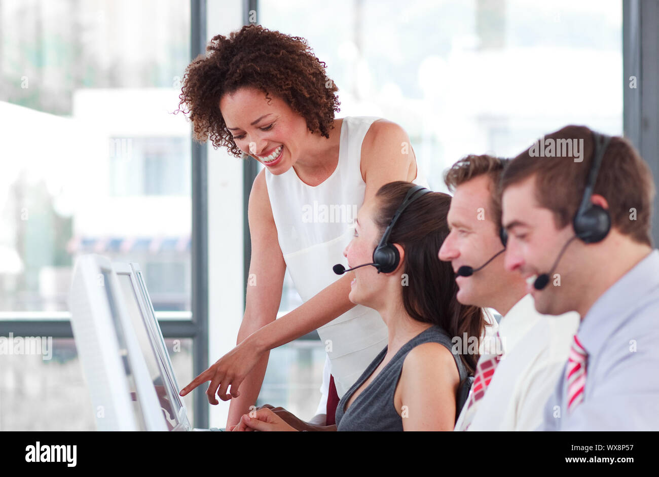 Jolly female manager with her sale representative team at work Stock ...