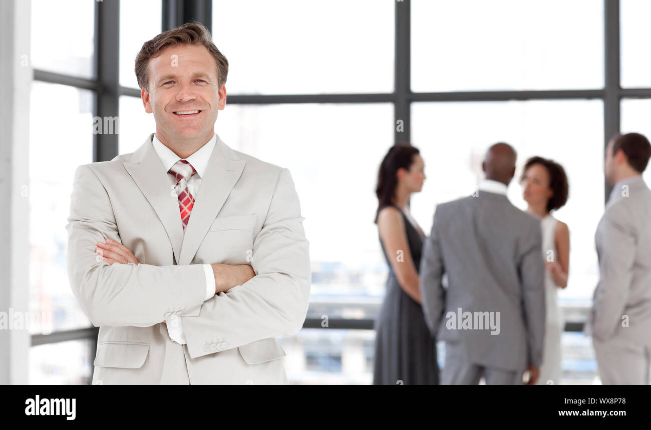 Professional confident male manager leading his team in a office Stock ...