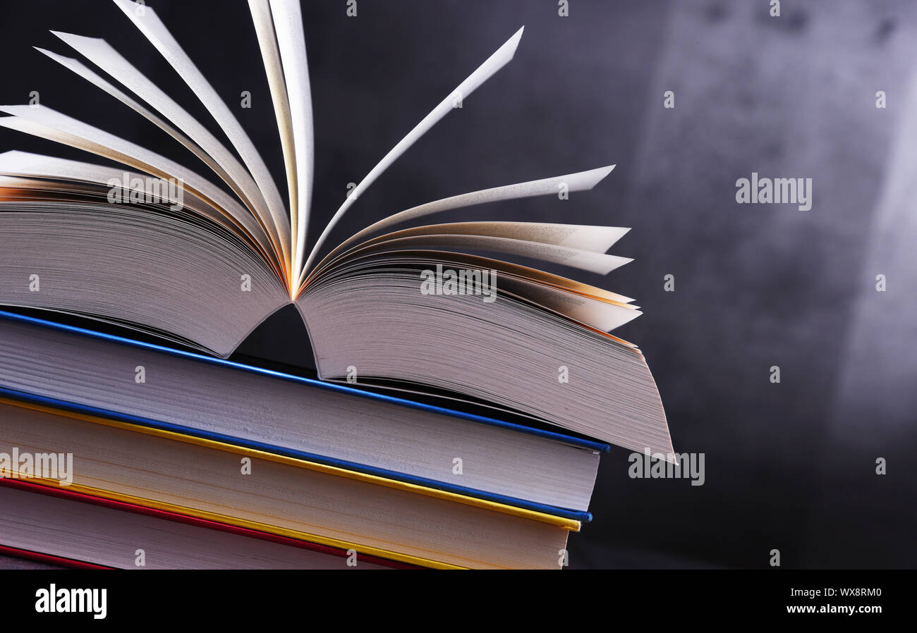 Composition with open book on the table Stock Photo - Alamy