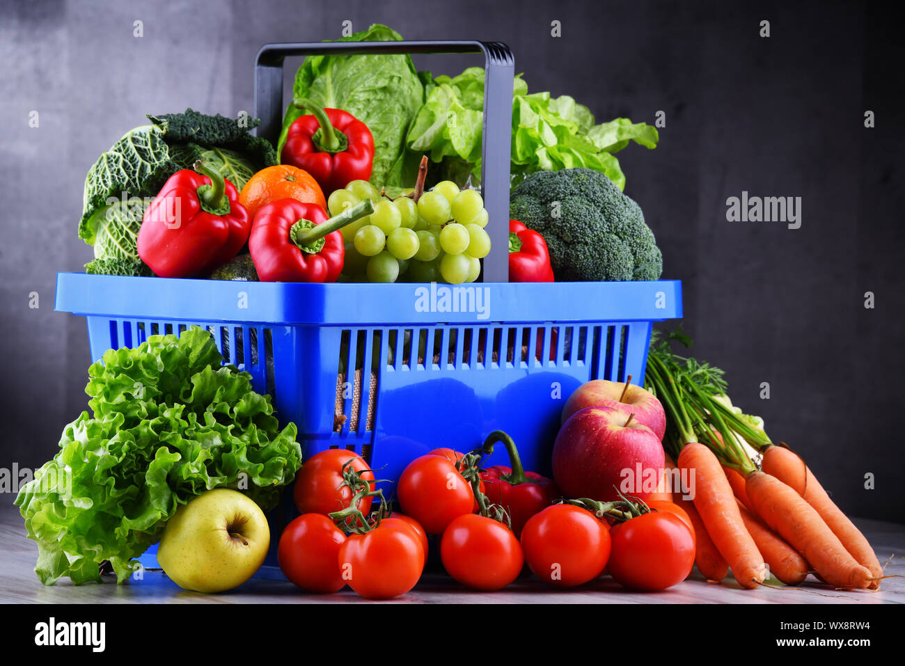 Fresh organic fruits and vegetables in plastic shopping basket Stock ...
