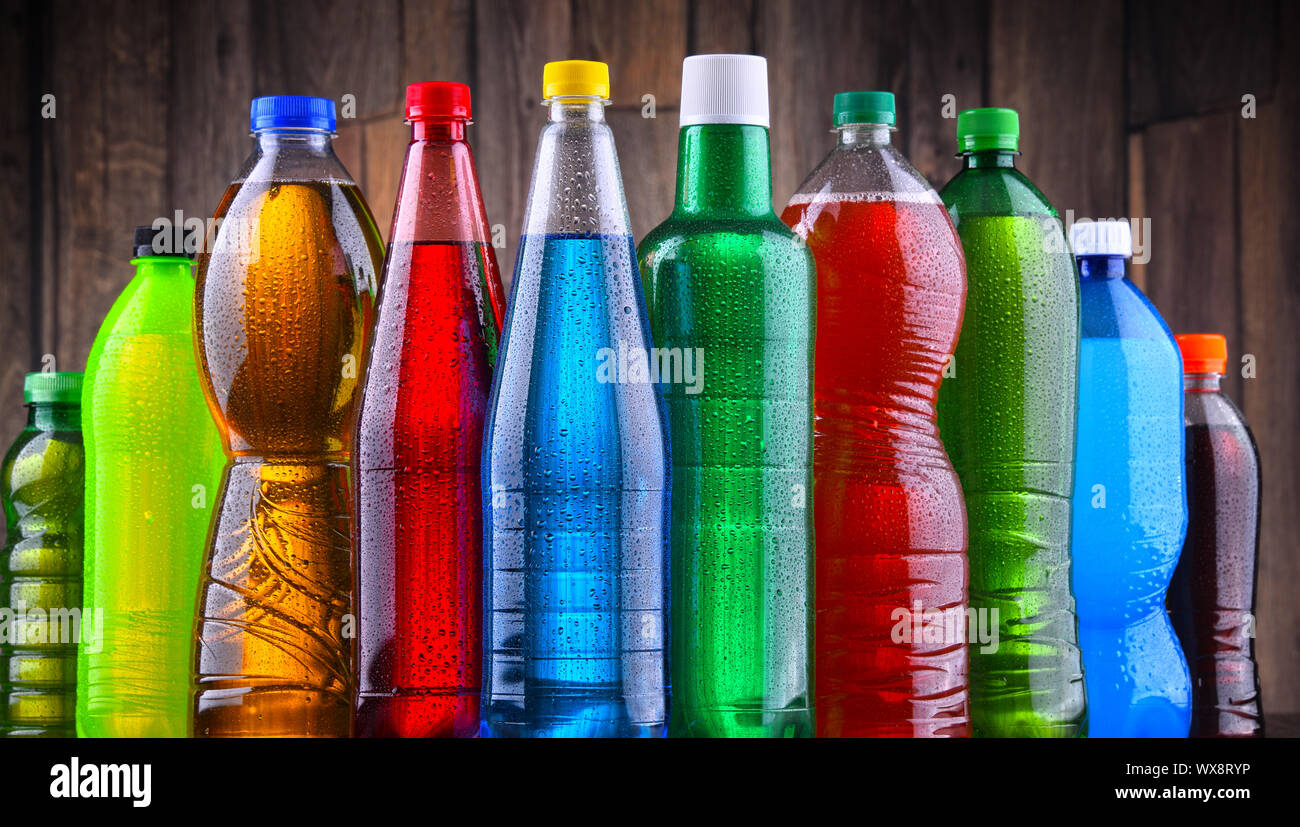 Plastic bottles of assorted carbonated soft drinks in variety of colors ...
