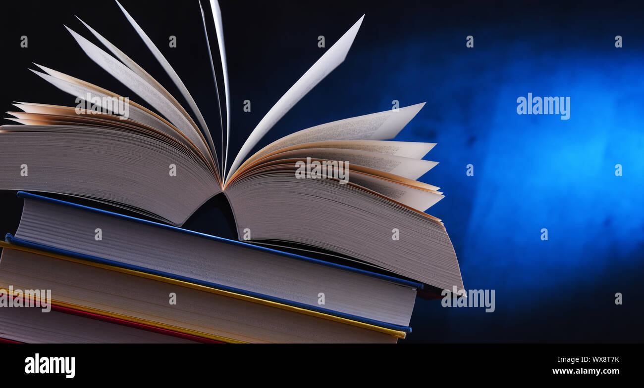 Composition with open book on the table Stock Photo - Alamy