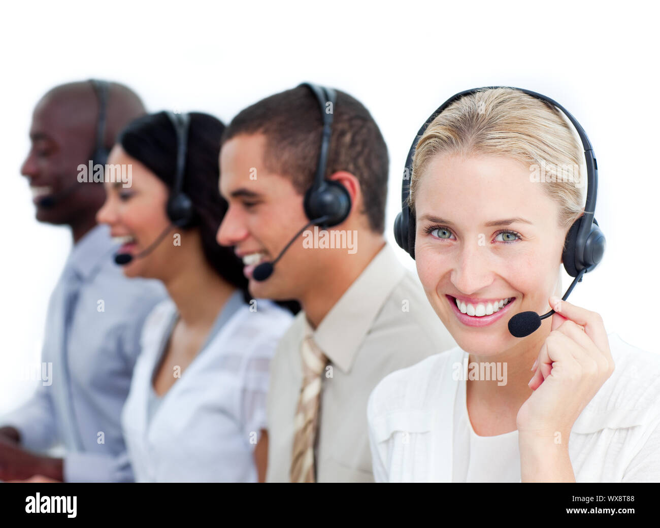 Blond businesswoman and her team working in a call center against a ...