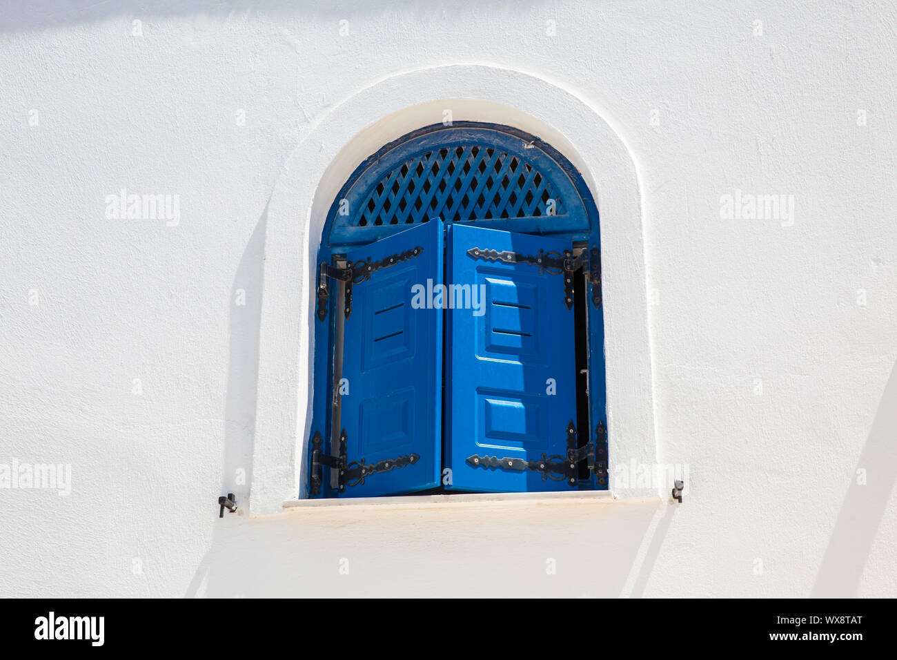 Traditional beautiful blue windows over white walls in Santorini Island ...