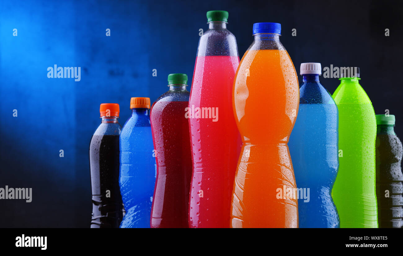 Plastic bottles of assorted carbonated soft drinks in variety of colors ...