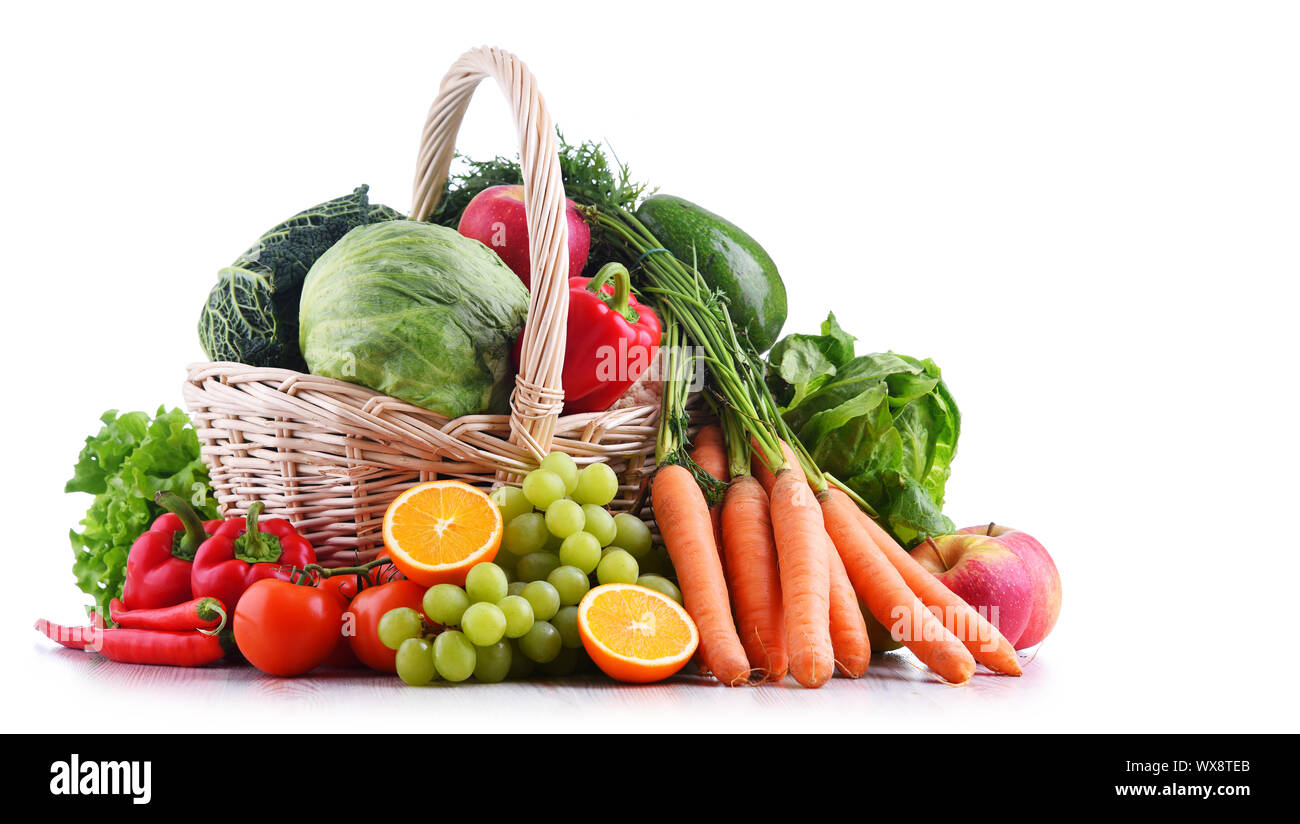 Fresh organic fruits and vegetables in wicker basket isolated on white ...