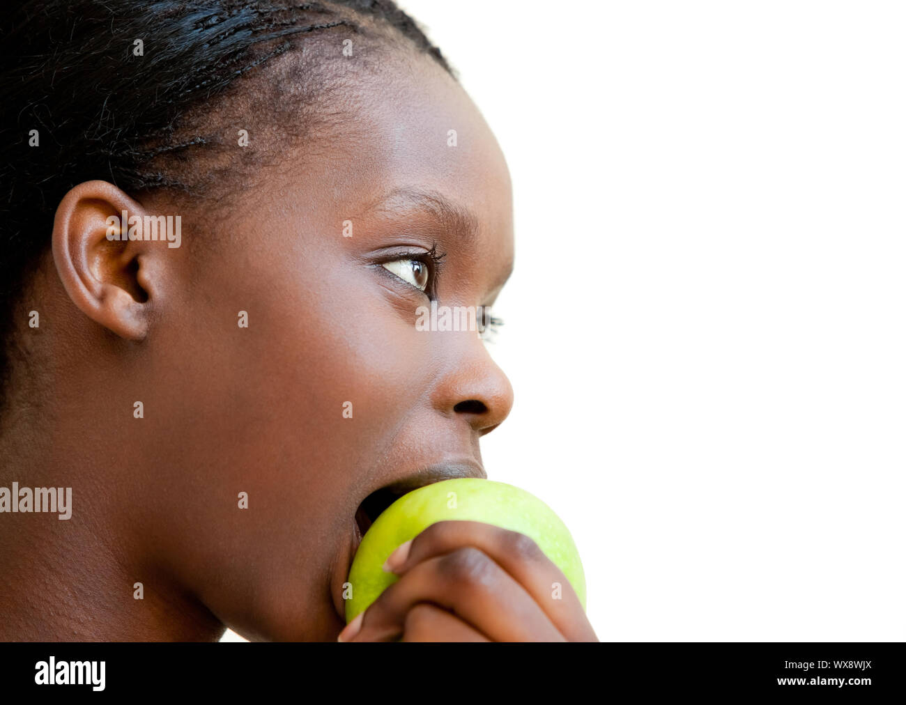 Cute woman eating apple against white background Stock Photo - Alamy