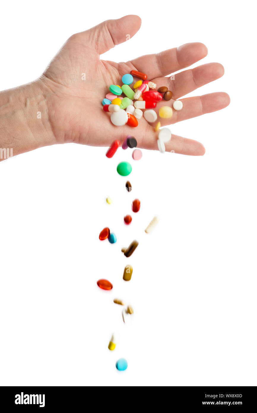 Hand and falling pills Stock Photo - Alamy