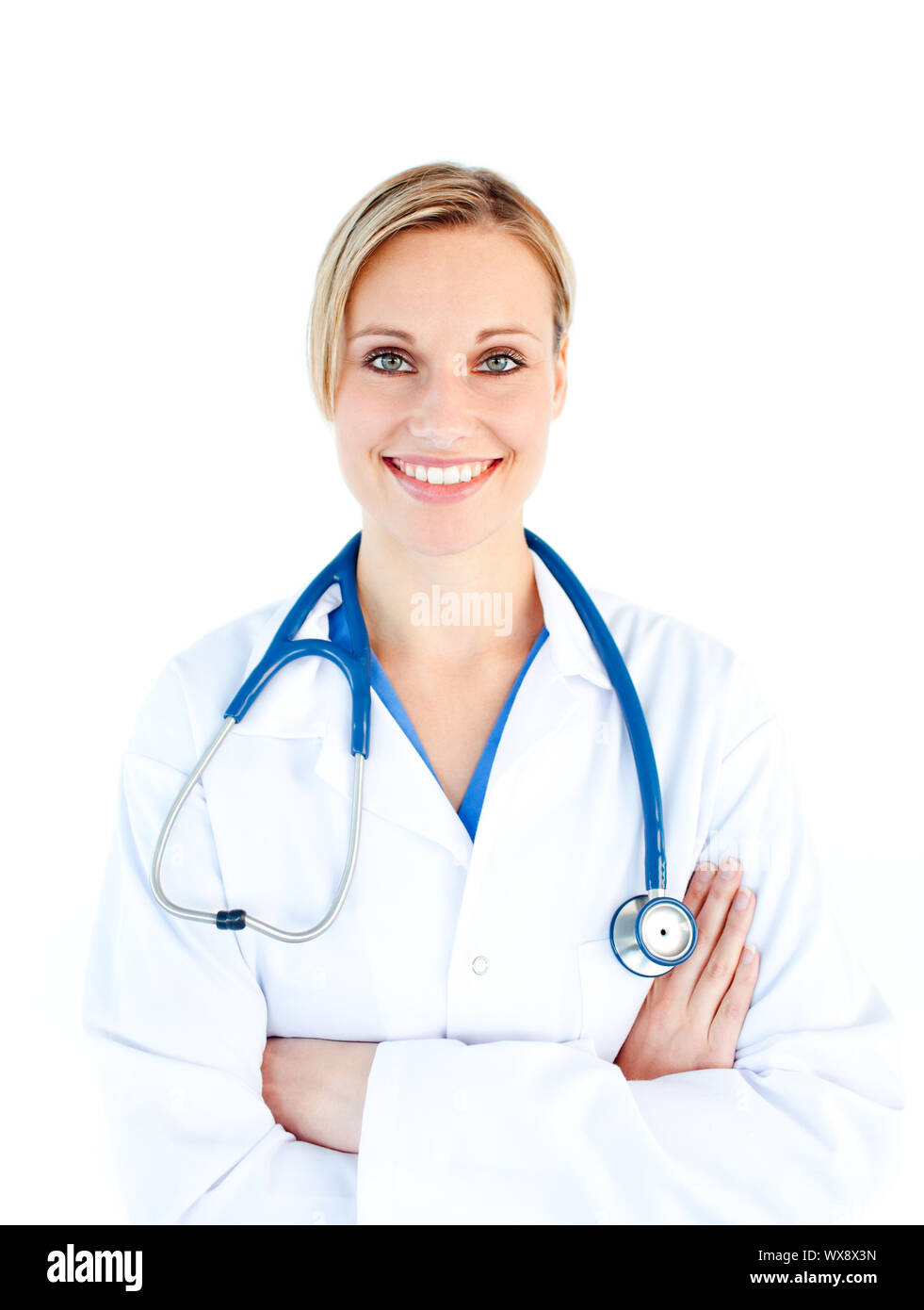 Assertive female doctor smiling at the camera against white background ...