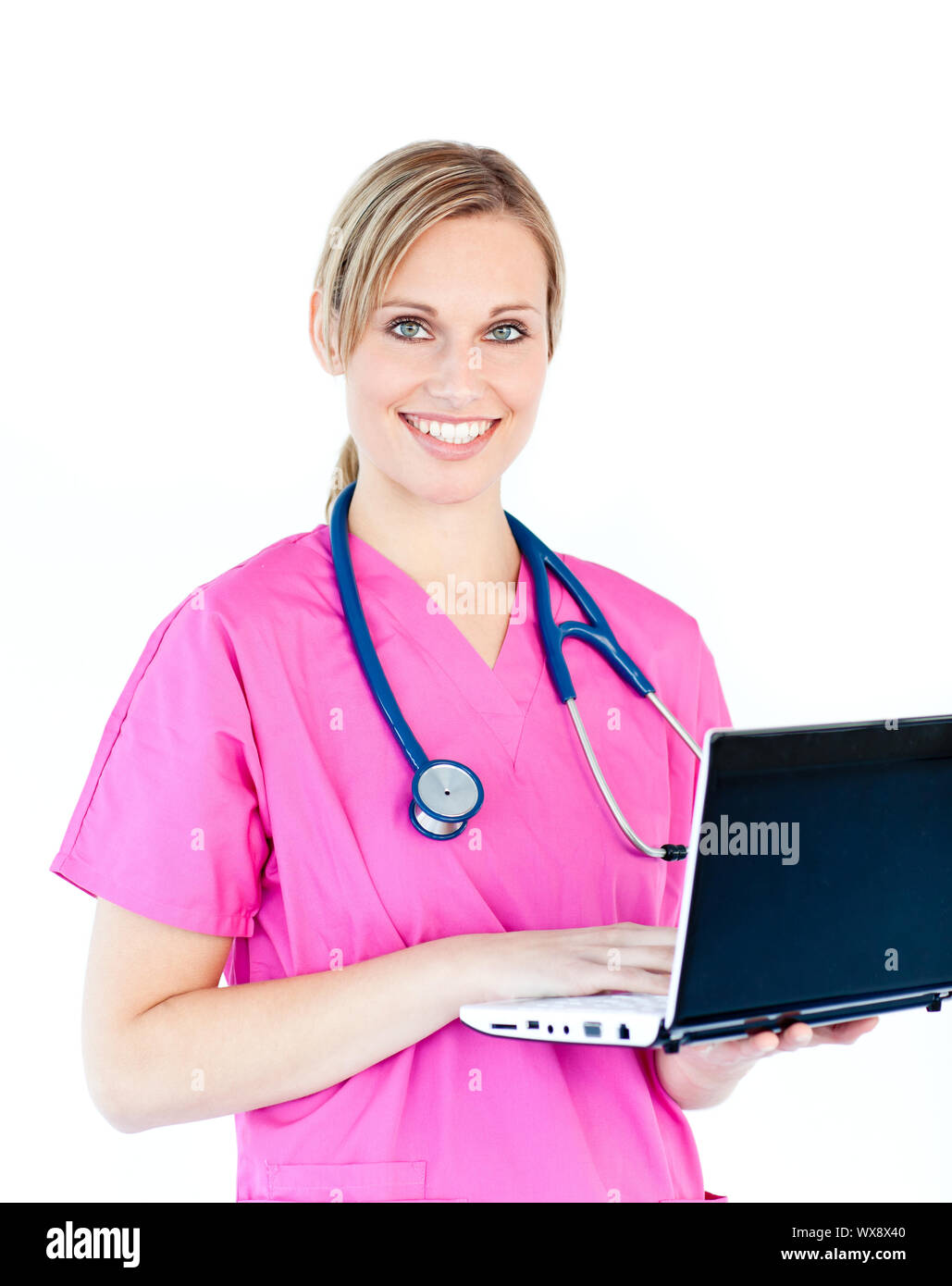 Delighted female nurse holding a laptop smiling at the camera against ...