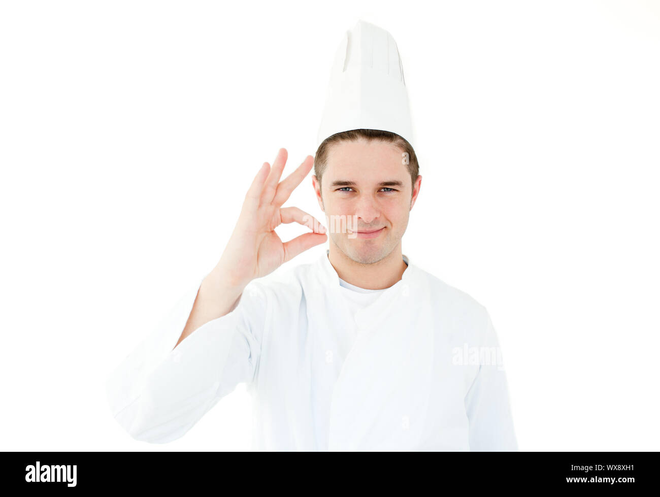 Handsome cook giving hand signal against white background Stock Photo ...
