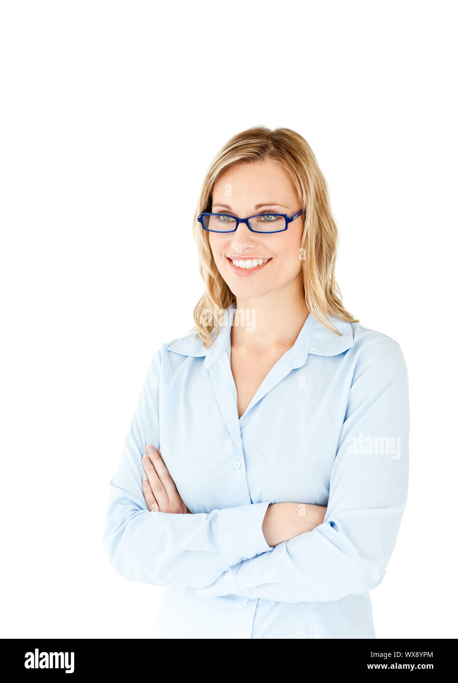 Confident businesswoman with folded arms smiling at the camera against ...