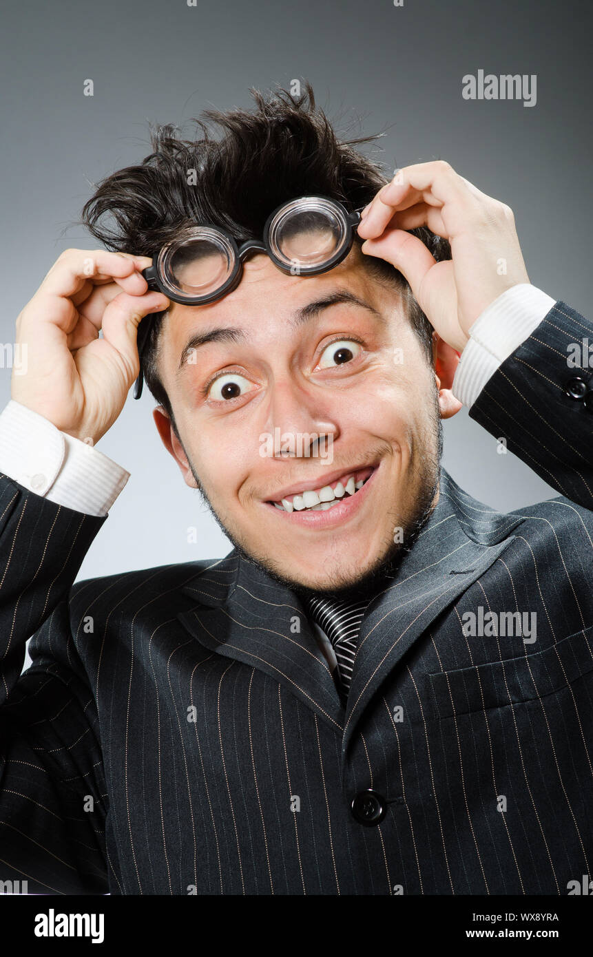 Funny nerd businessman in dark studio Stock Photo - Alamy