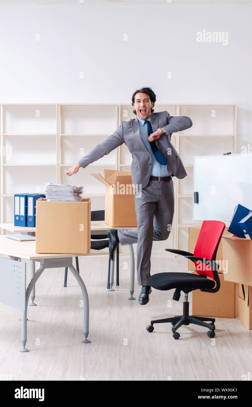 Young man employee with boxes in the office Stock Photo - Alamy
