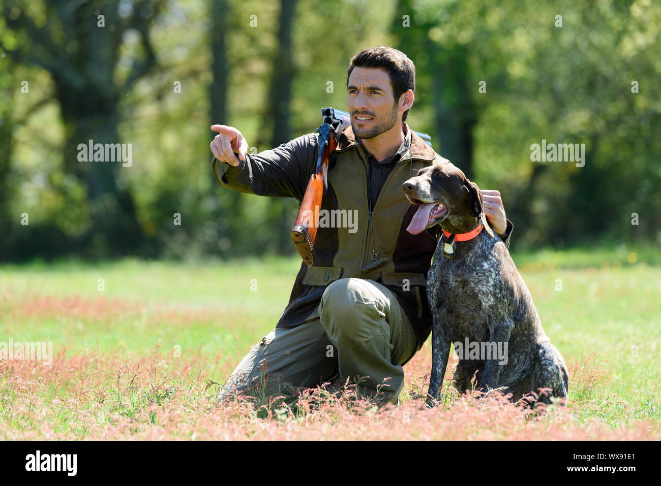 hunter and his dog looking at something Stock Photo - Alamy