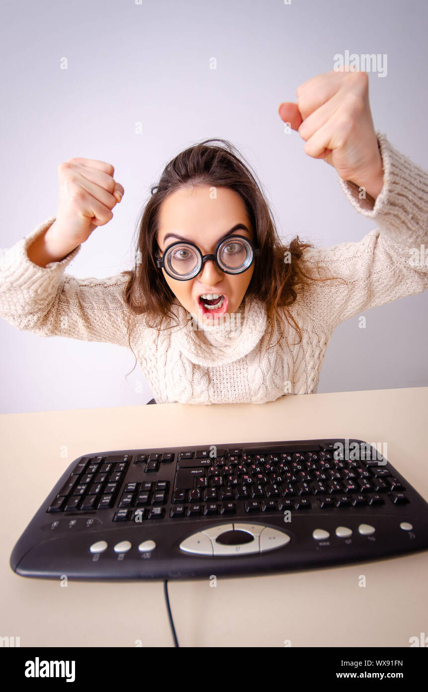 Funny nerd girl working on computer Stock Photo - Alamy