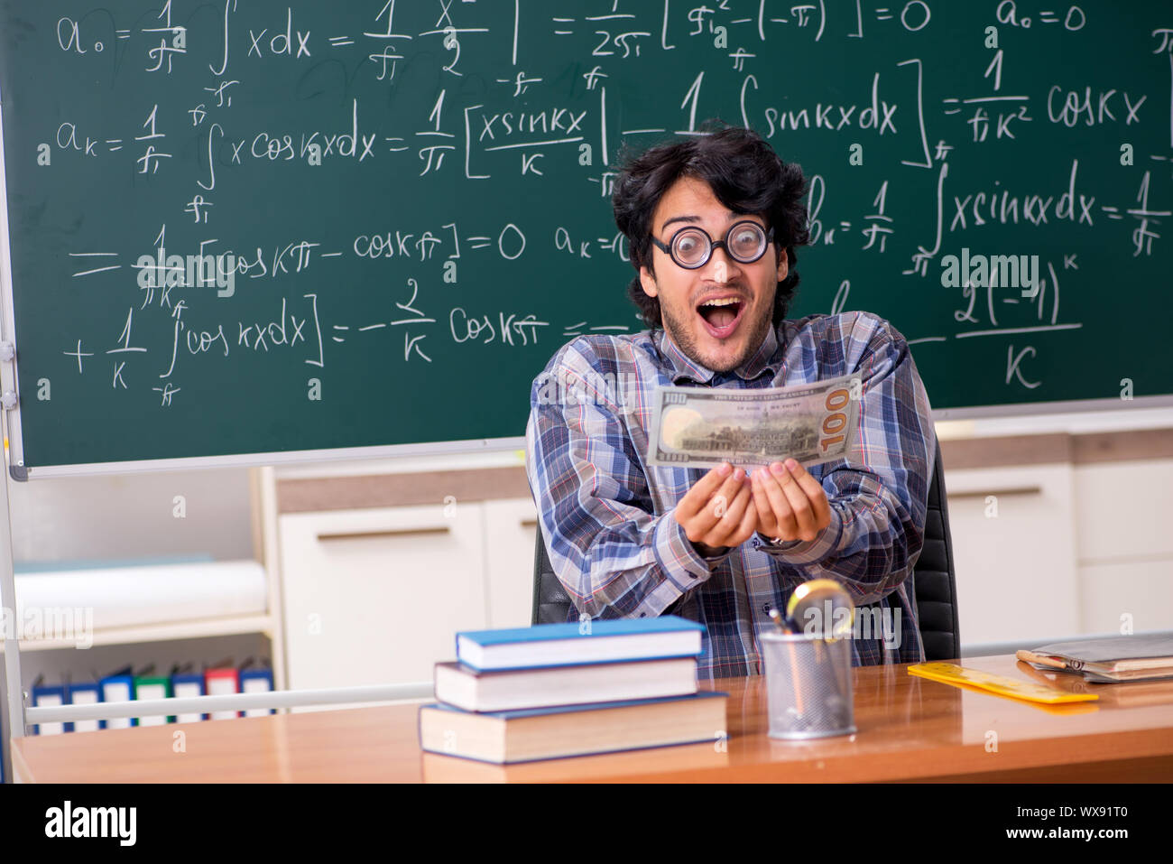 Funny male math teacher in the classroom Stock Photo - Alamy