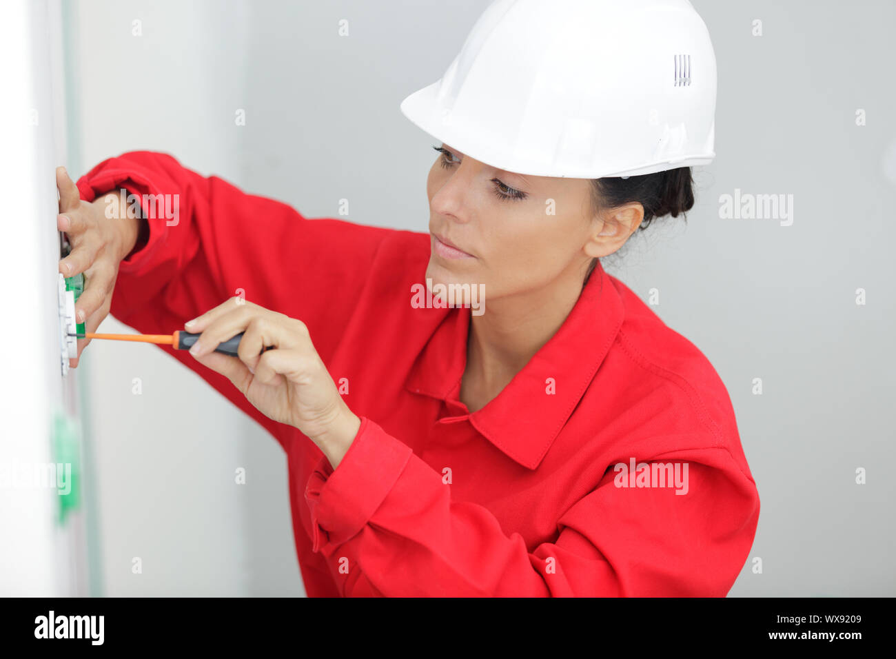 female electrician fixing socket electricity problem Stock Photo - Alamy