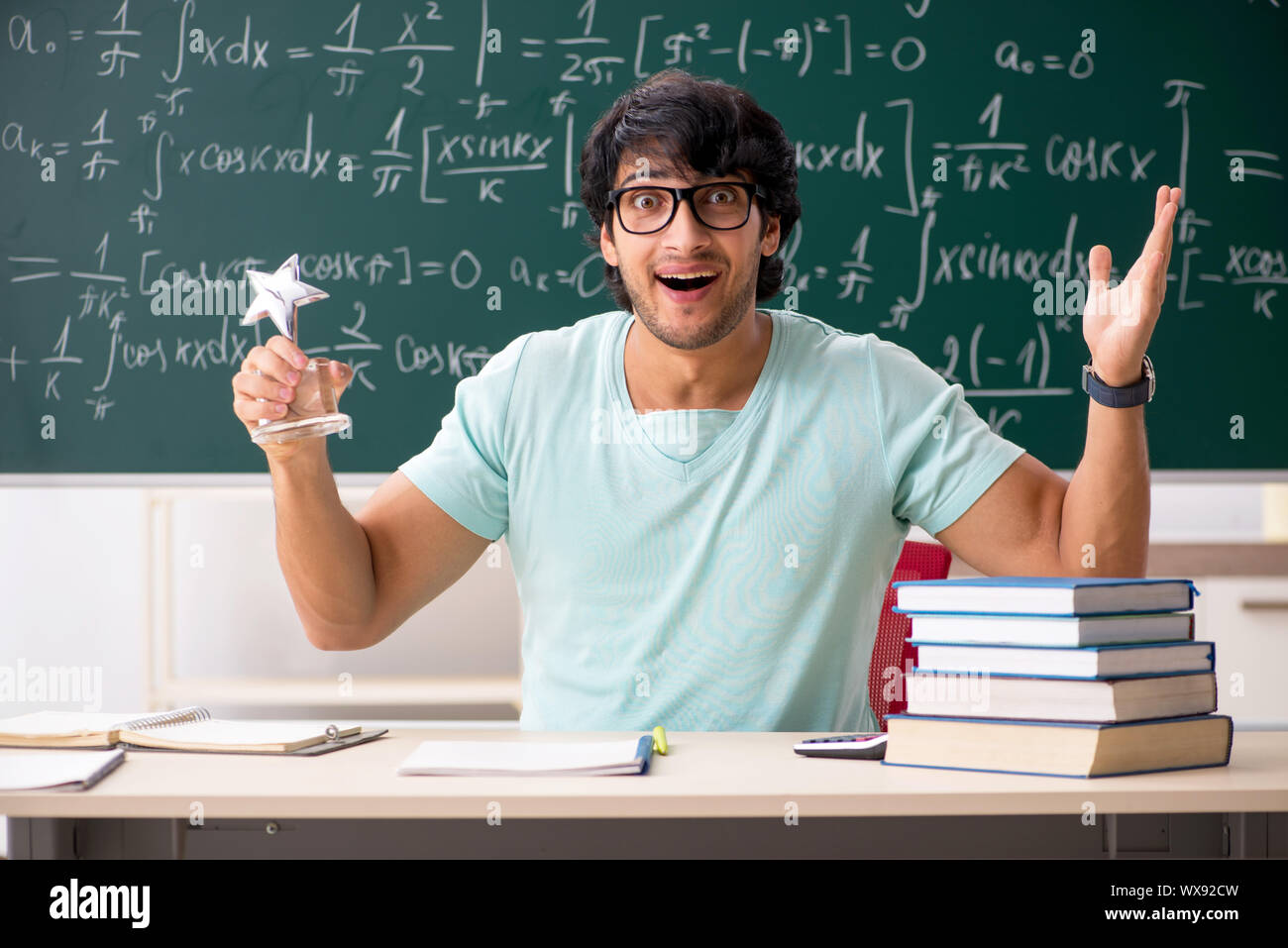 Young male student mathematician in front of chalkboard Stock Photo - Alamy