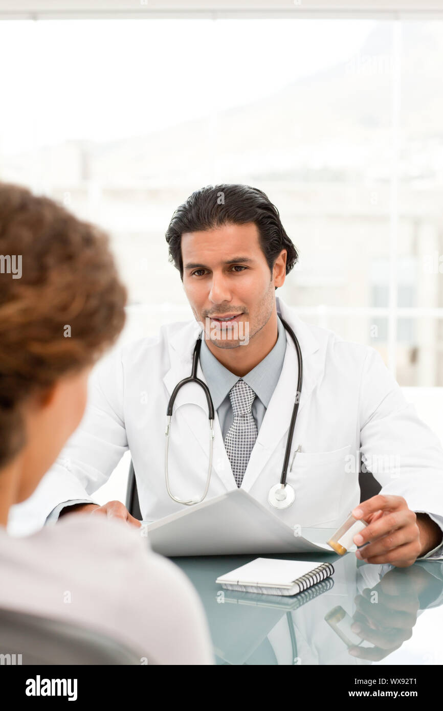 Rear view of a female patient during an appointment with her doctor at ...