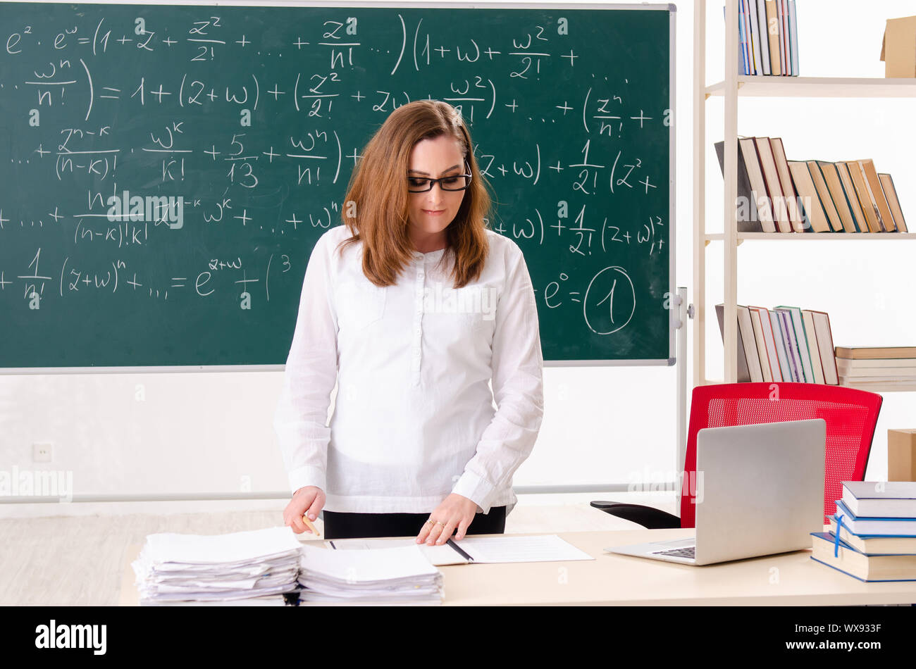 Female math teacher in the classroom Stock Photo - Alamy