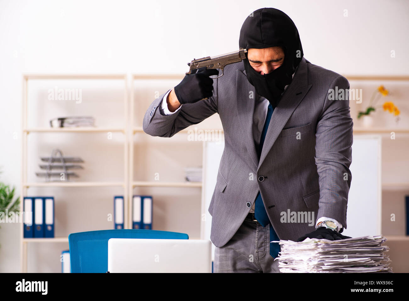 Male gangster stealing information from the office Stock Photo - Alamy