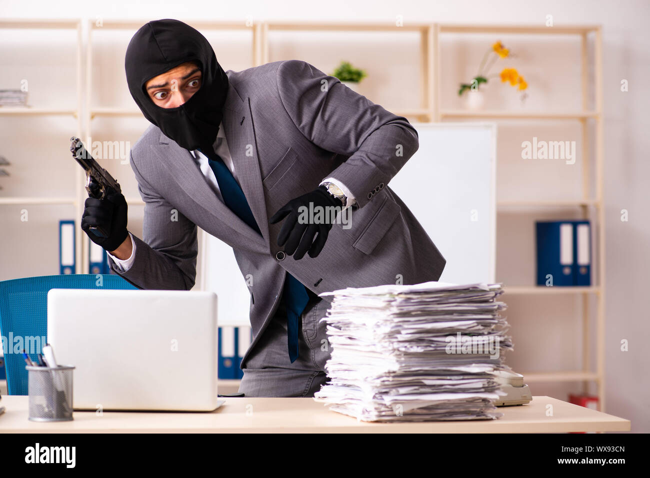 Male gangster stealing information from the office Stock Photo - Alamy