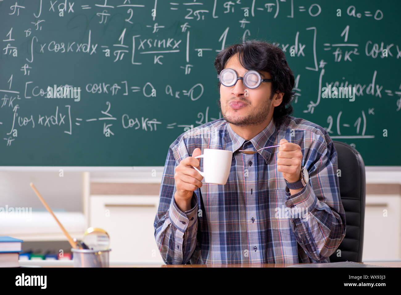 Funny male math teacher in the classroom Stock Photo - Alamy