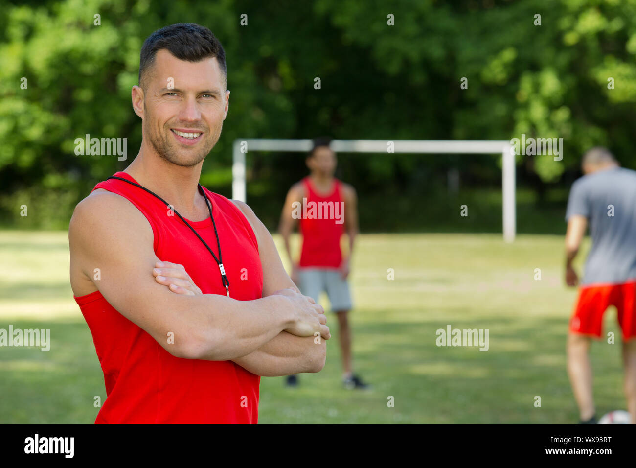 a football coach posing confidently Stock Photo - Alamy