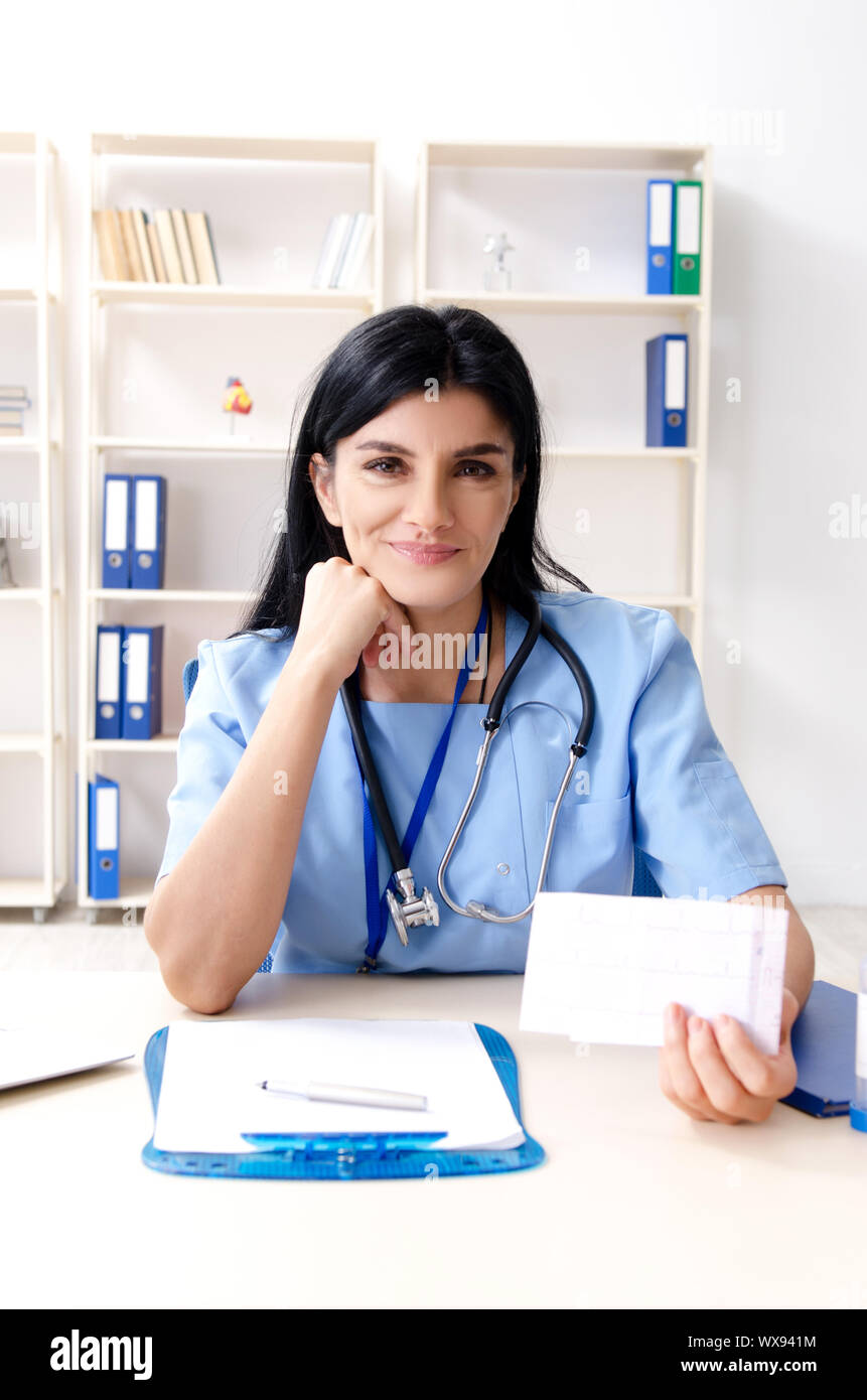 Doctor cardiologist examining electrocardiogram hi-res stock ...