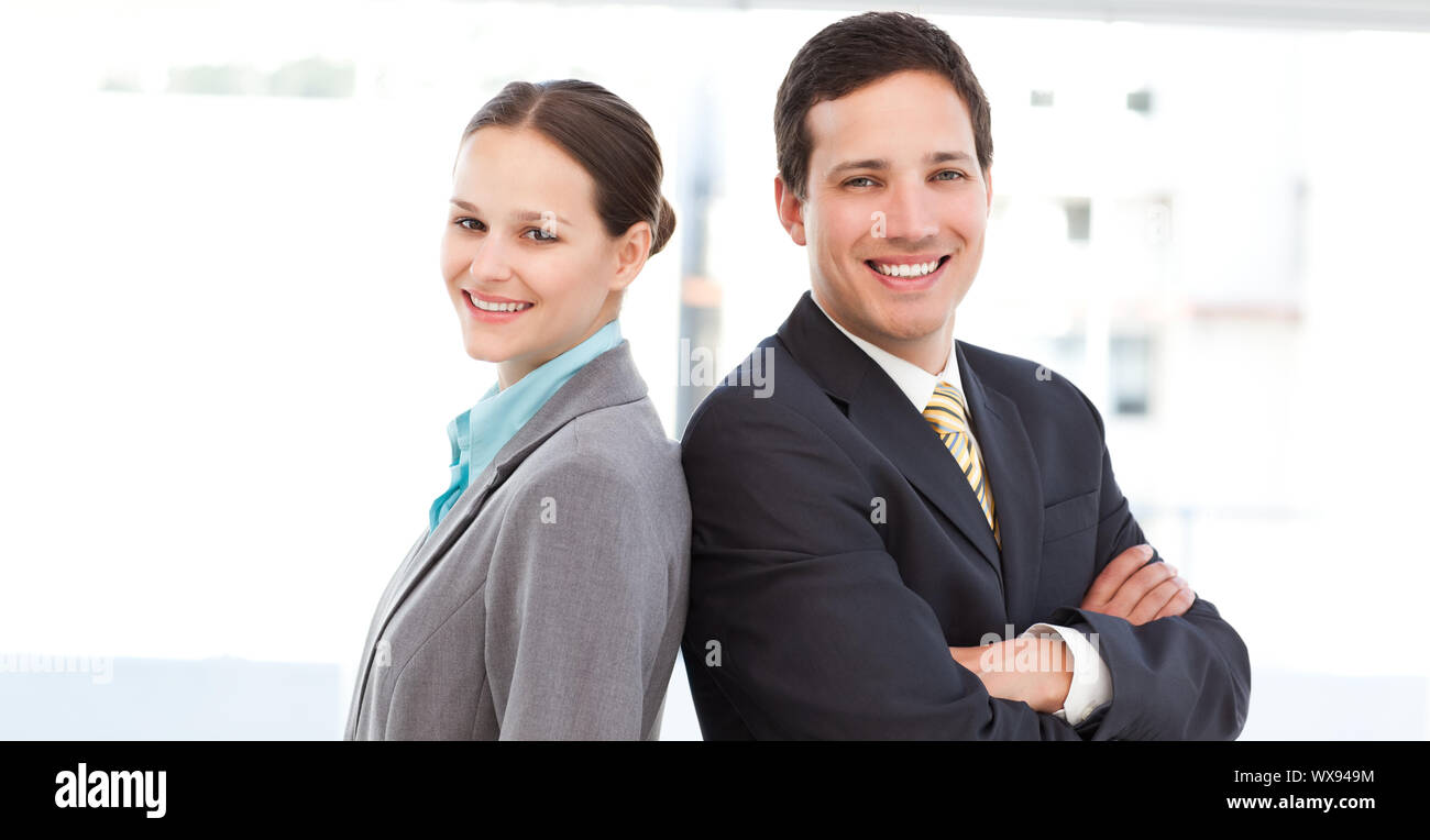 Happy partners posing togetherback to back at work Stock Photo - Alamy