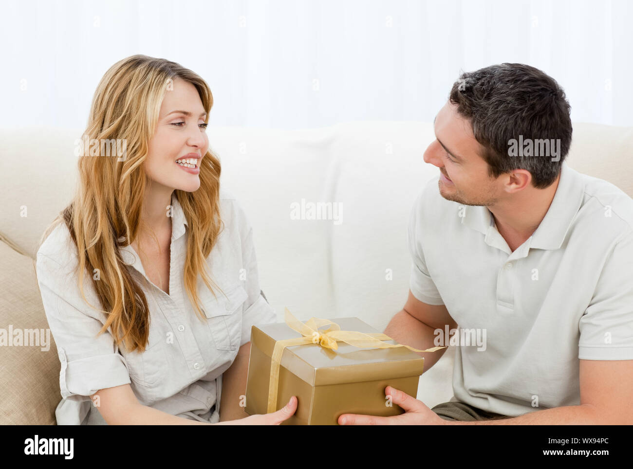 Man offering a gift to his wife Stock Photo - Alamy