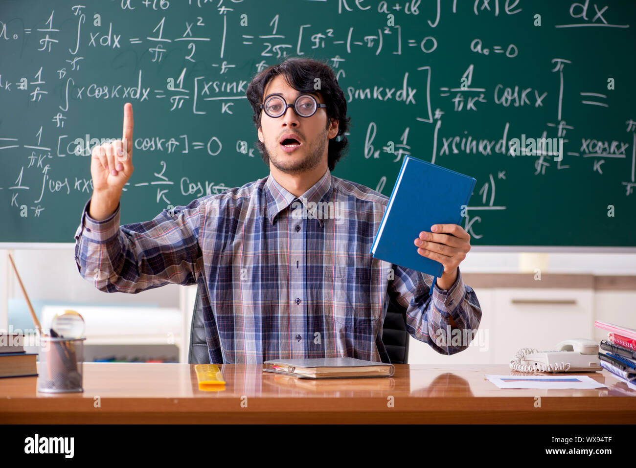 Funny male math teacher in the classroom Stock Photo - Alamy
