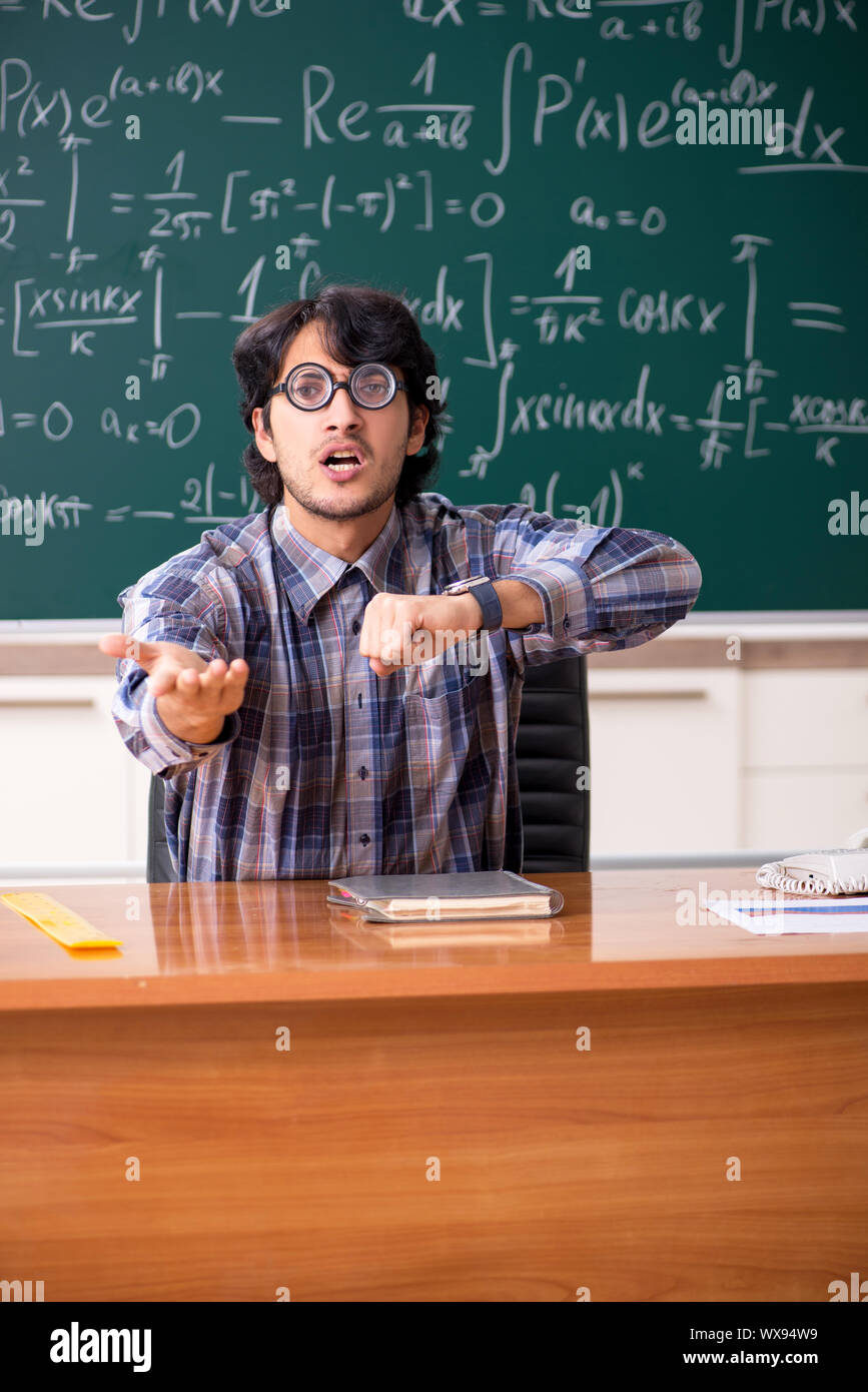 Funny male math teacher in the classroom Stock Photo - Alamy