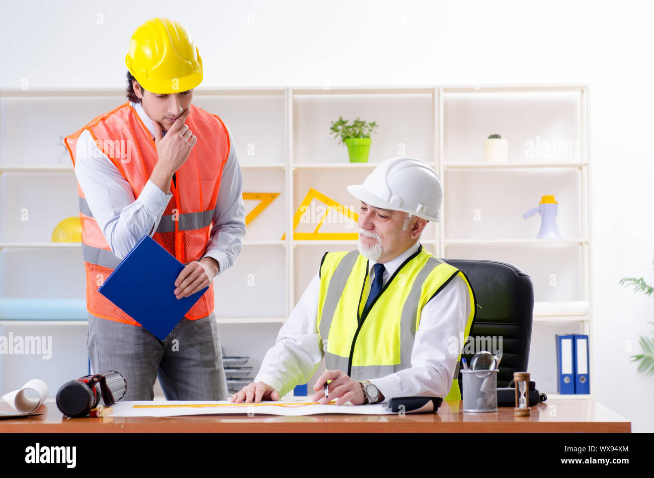 Two engineers colleagues working under project Stock Photo - Alamy