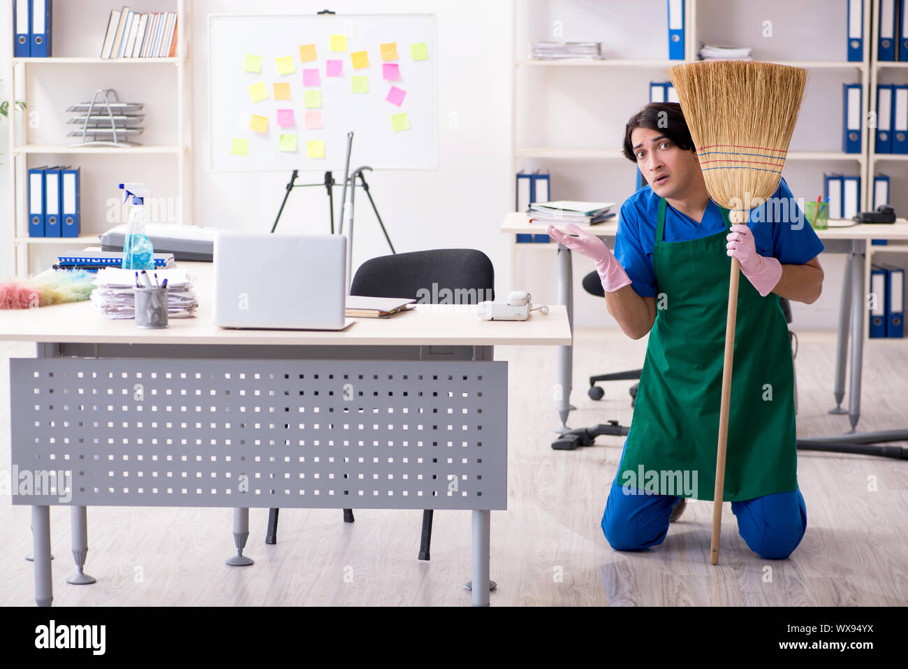 Male handsome professional cleaner working in the office Stock Photo ...